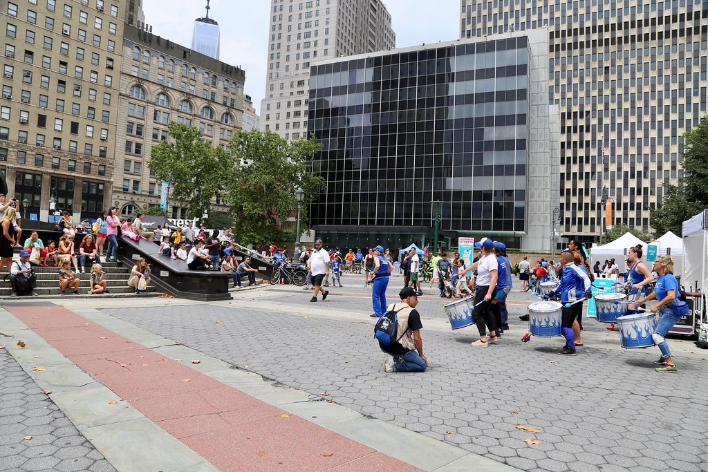 Summer Streets Festival at Foley Square, New York City (Aug 11, 2018): Blue-drum corps energize the crowd against a modern cityscape