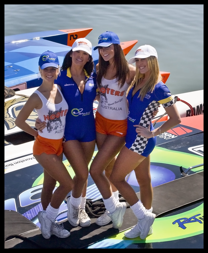 Promotional models pose on colorful powerboats at Redcliffe Power Boat Racing, Sunday afternoon