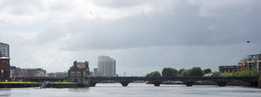 Five-arch Sarsfield Bridge over the River Shannon, Limerick, under a moody, cloud-filled sky