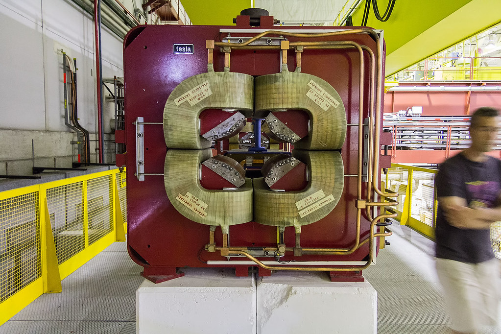 CERN antimatter trap magnet: four-lobed toroidal coil assembly in a red enclosure inside a particle physics lab