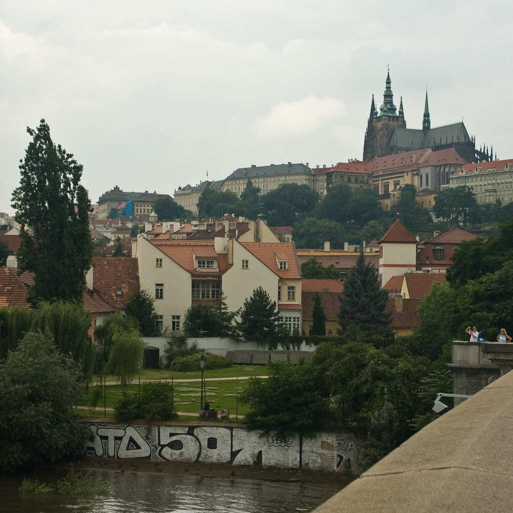 Prague Castle Over the Old Town: Riverside View of Red Rooftops and Gothic Spires