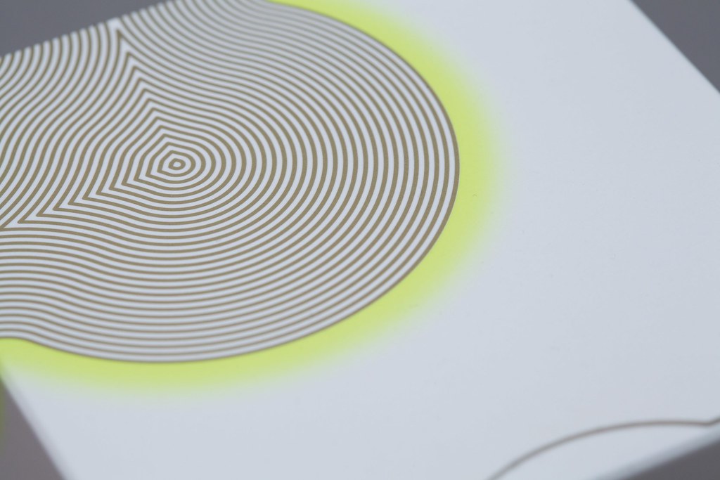 Yauatcha packaging: close-up of a concentric spiral motif with neon-yellow glow
