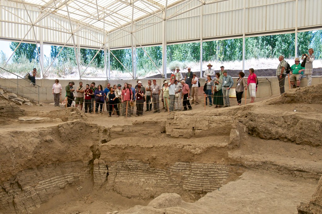 Archaeological Site Tour: Visitors Observe Exposed Stratigraphy Beneath a Protective Shelter