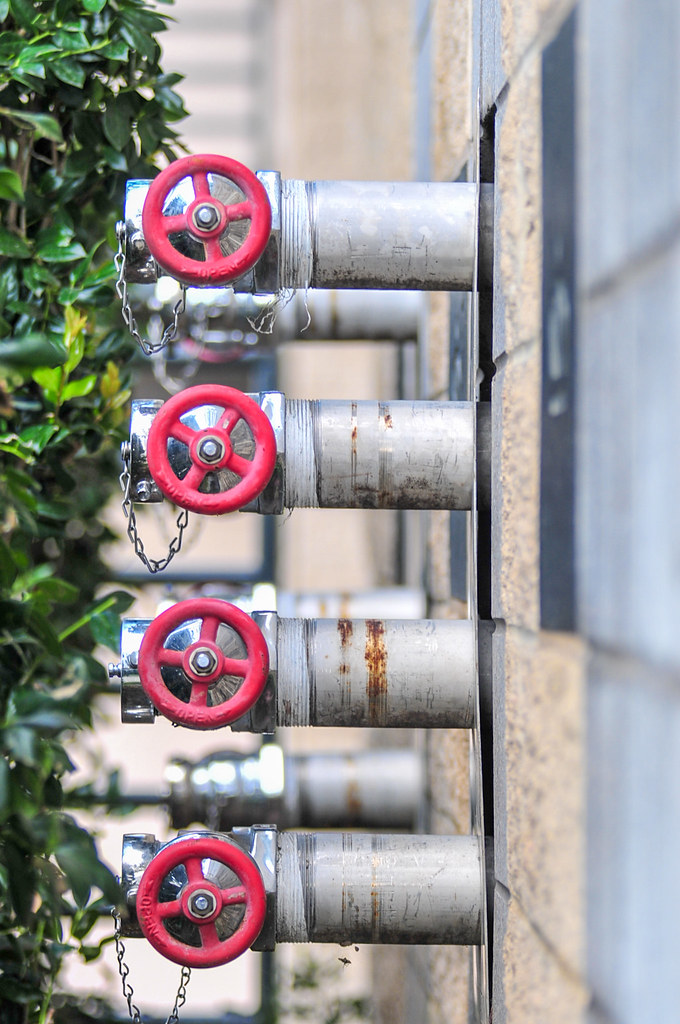 multiple fire department connections on a building wall | Flickr