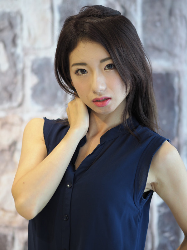 Three-quarter portrait of a woman in a navy sleeveless blouse, captured with Olympus E-M1 Mark II and M.Zuiko Digital ED 75mm f/1.8