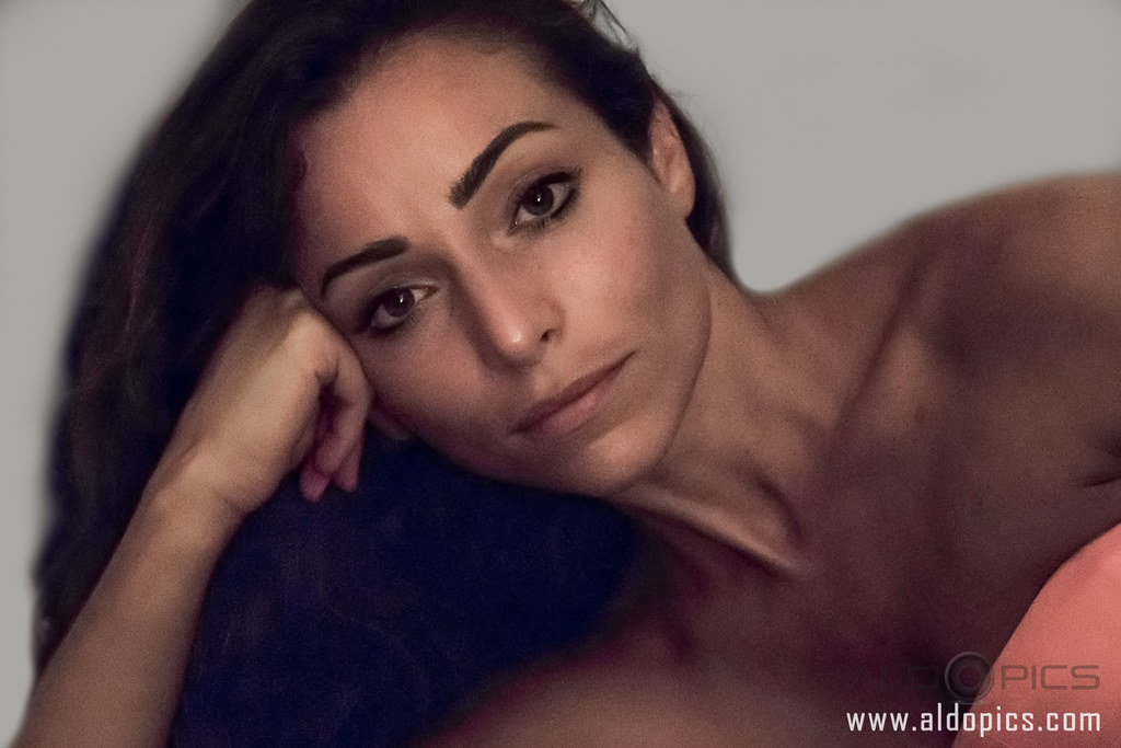 AldoPics: Intimate Portrait of a Woman Reclining in Soft Studio Light