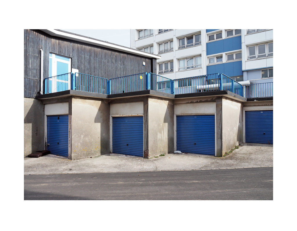 Blue-Doors Garage Row Under Elevated Balcony, Devonport, Plymouth