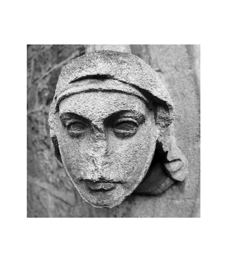 In-situ weathered stone head relief emerging from rock, Plymouth, Devon, England