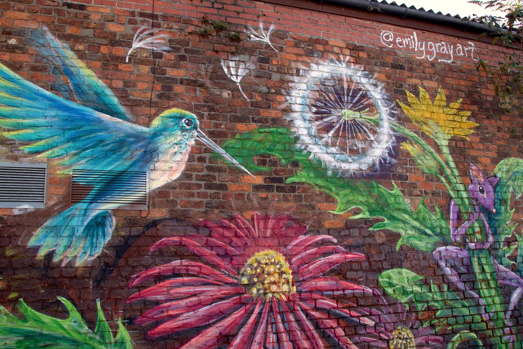Hummingbird and Blooms: a vivid mural by Emily Gray on a brick wall in Liverpool's Baltic Triangle