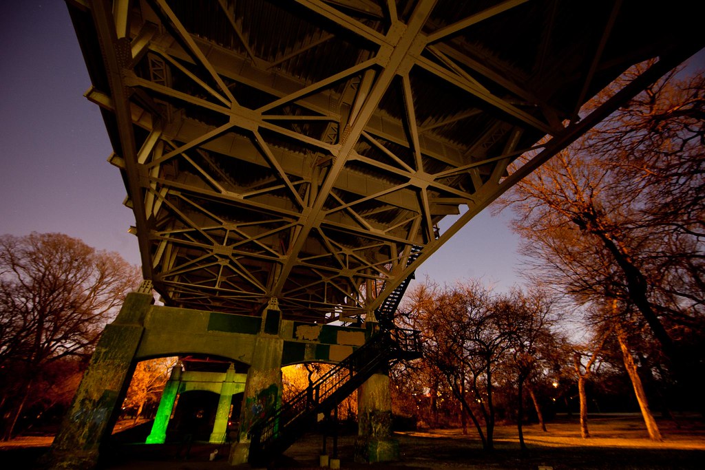 Under the Park Bridge: Wide-Angle Night View of Steel Truss and Warm Illumination