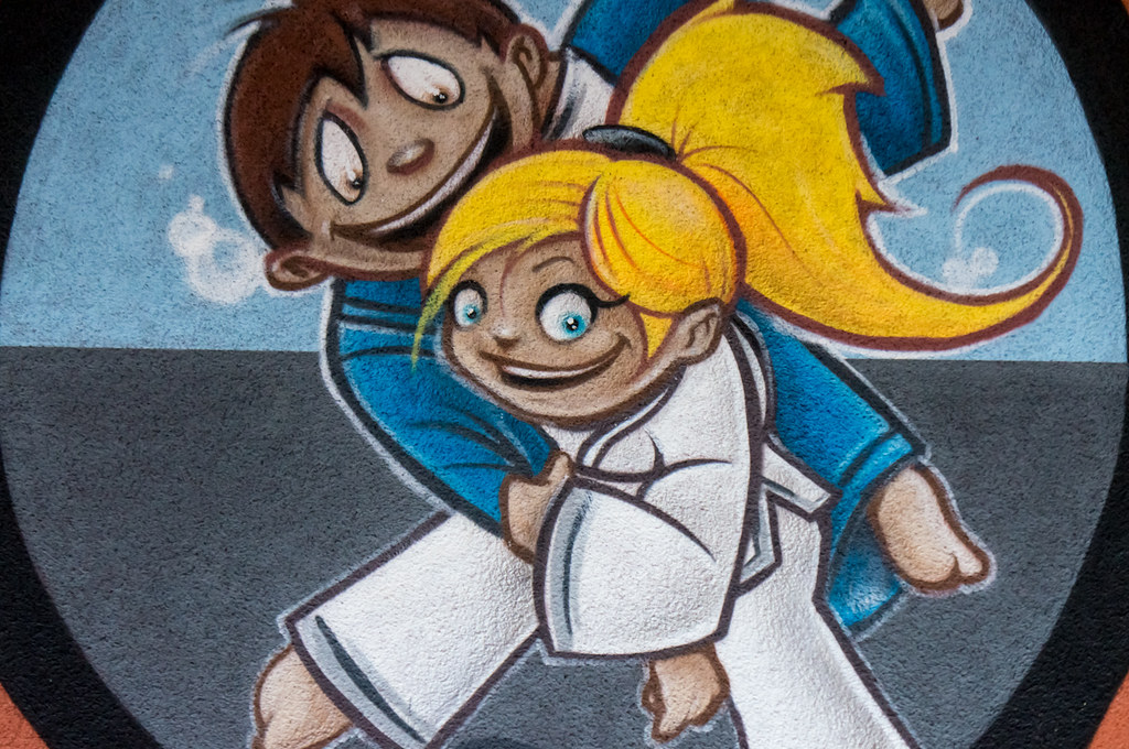 Martial Arts Mural: Playful Karate Duo in a Circular Street Artwork, Calle de Velázquez