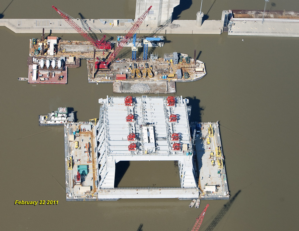 Aerial view of Olmsted Locks and Dam construction: LP1 shell afloat amid cranes and support vessels (Feb 22, 2011)