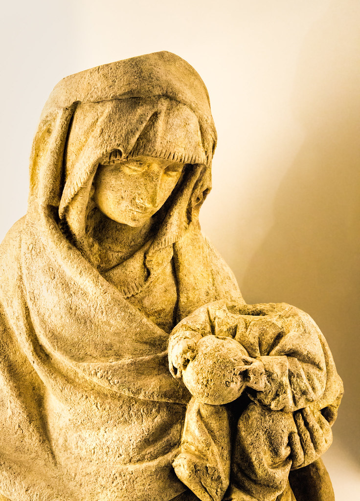 Madonna and Child in Stone: Contemplative Veiled Figure with Infant