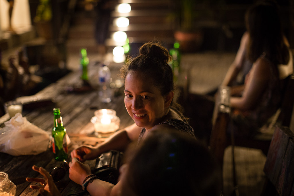 Candlelit Bali Evening: A candid gathering around a weathered wooden table
