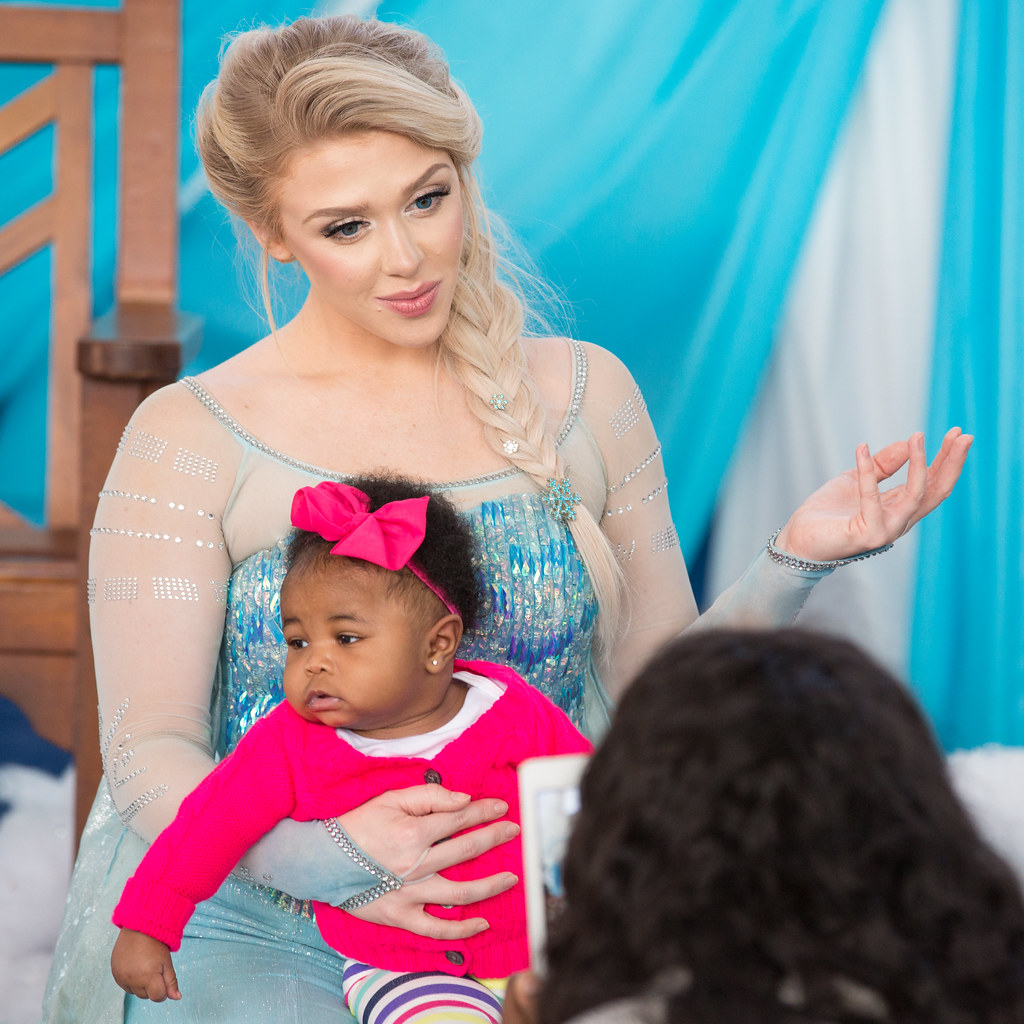 Winter Wonderland: Ice-princess performer cradles a baby at North Charleston preschool holiday event