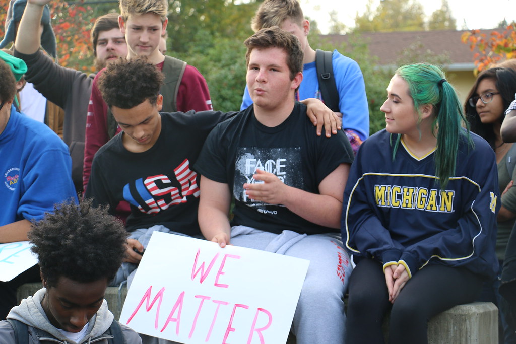 We Matter rally: Diverse group of teens gathered outdoors with prominent 'WE MATTER' sign