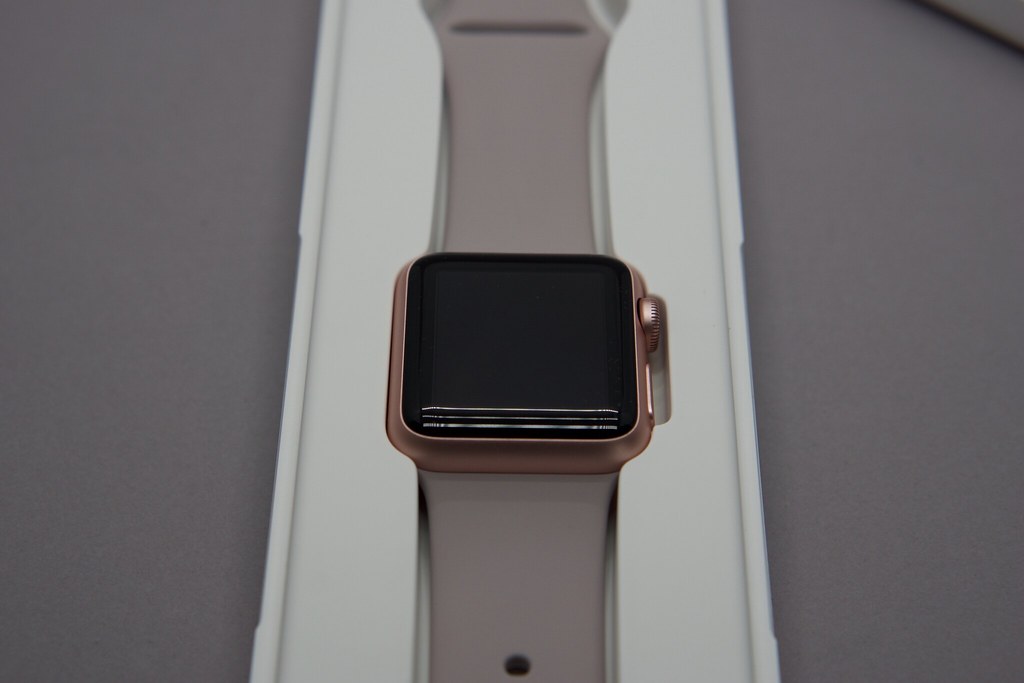Rose Gold Apple Watch Sport with Sand Band in White Retail Tray — Close-Up Unboxing Presentation