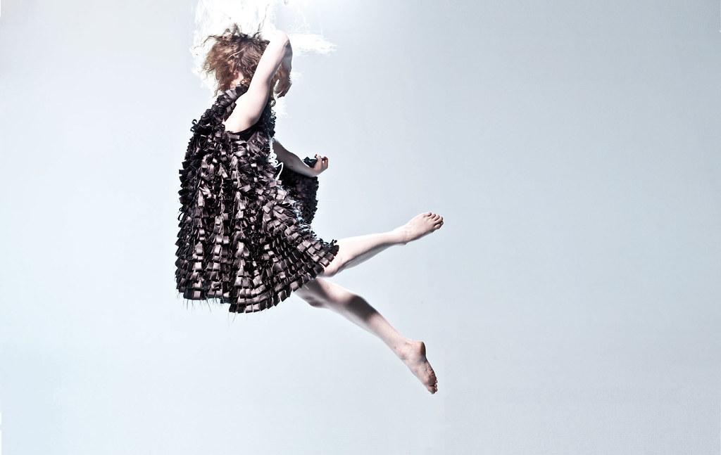 Robe Kurodori: mid-air study of a textured black dress in studio light