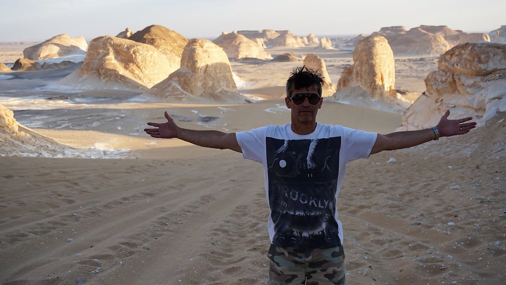 Arms Wide in the White Desert: Valley of Agabat’s limestone towers, Egypt