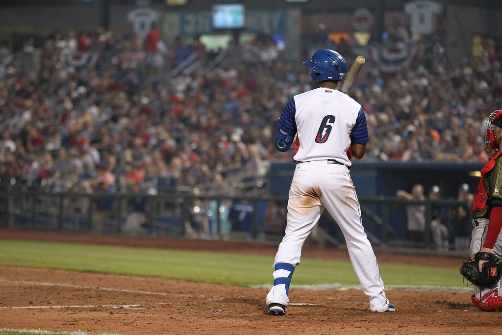 Number 6 at bat: back view of a baseball batter at home plate during a game