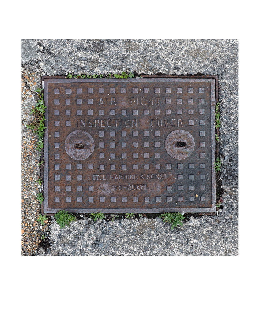 Air Tight Inspection Cover on Plymouth street, rusted cast-iron access plate by L. Harding & Sons, Torquay