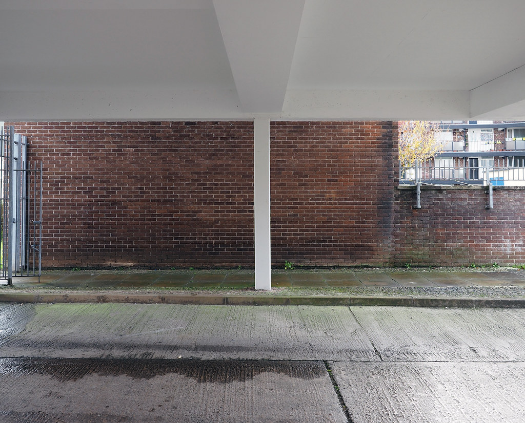Urban Underpass: Brick Walls Framed by a White Concrete Beam in Plymouth