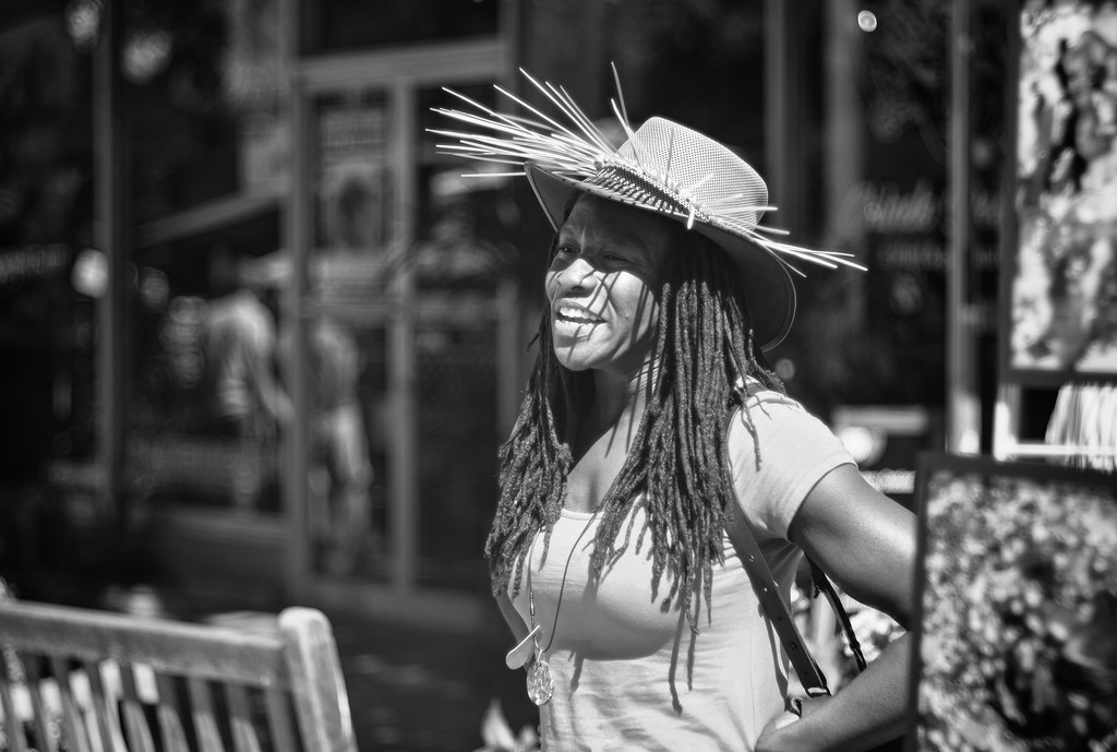 Candid portrait of a smiling festival-goer in a sunhat at the Los Altos Arts & Wine Festival