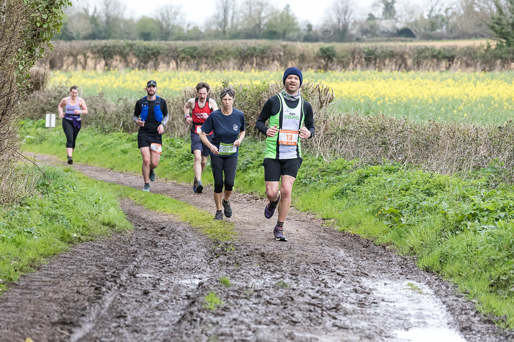 Runners on a muddy bridle path toward Kite Hill during the Dorset Ooser Badger Trail, Turnerspuddle area, 2023