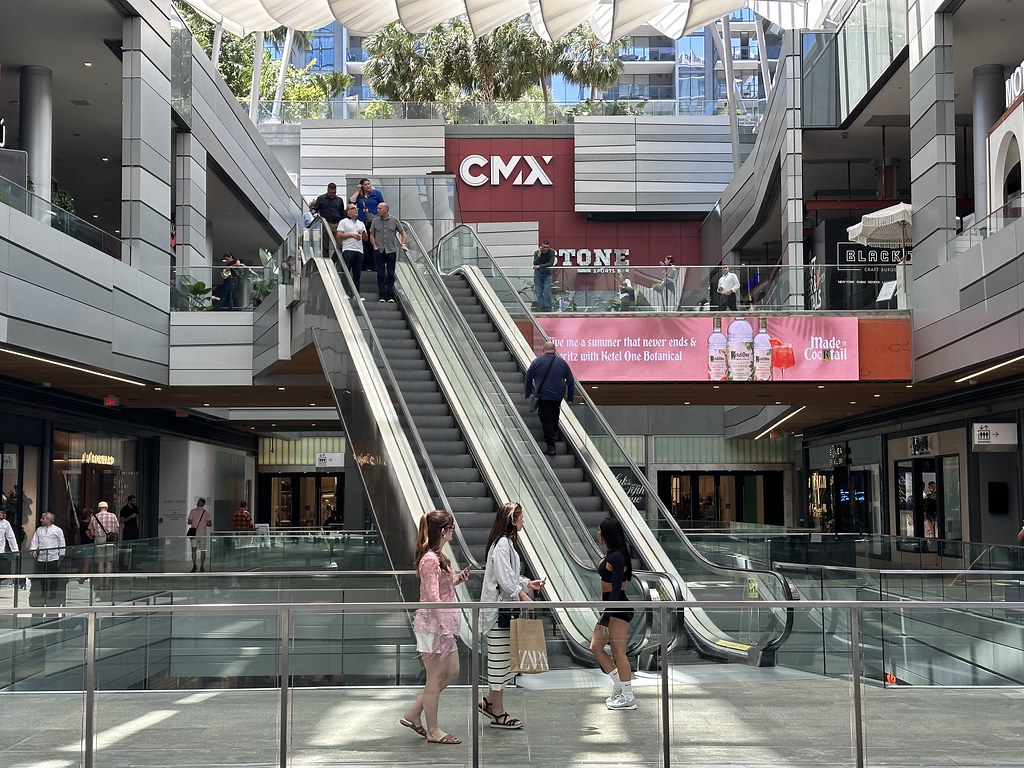 Brickell City Centre – CMX Theater Atrium: Sunlit multi-level escalators amid glass balconies and shoppers