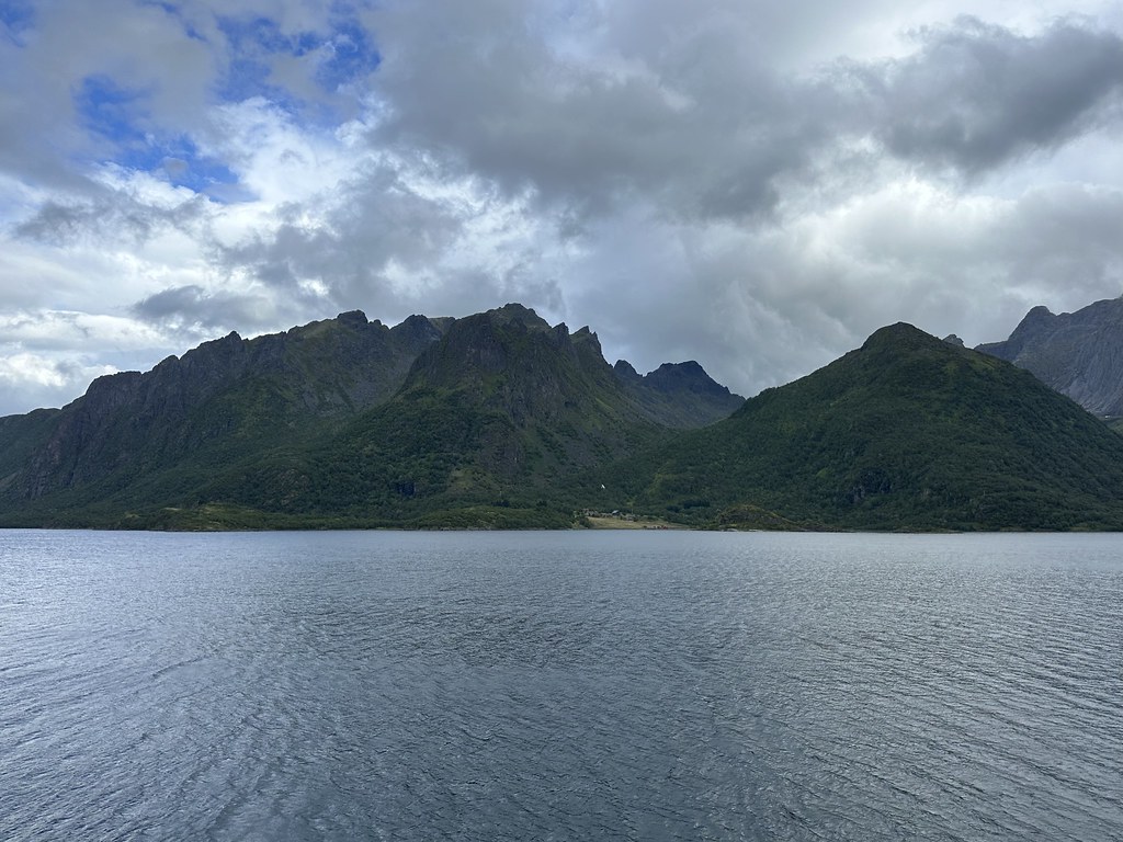 Dramatic landscape of the mountains and water under a cloudy sky near Hadsel, Nordland, Norway, August 2024