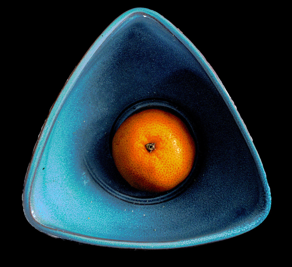 Orange Center in a Turquoise Triangular Dish: A Macro Study of Color Contrast