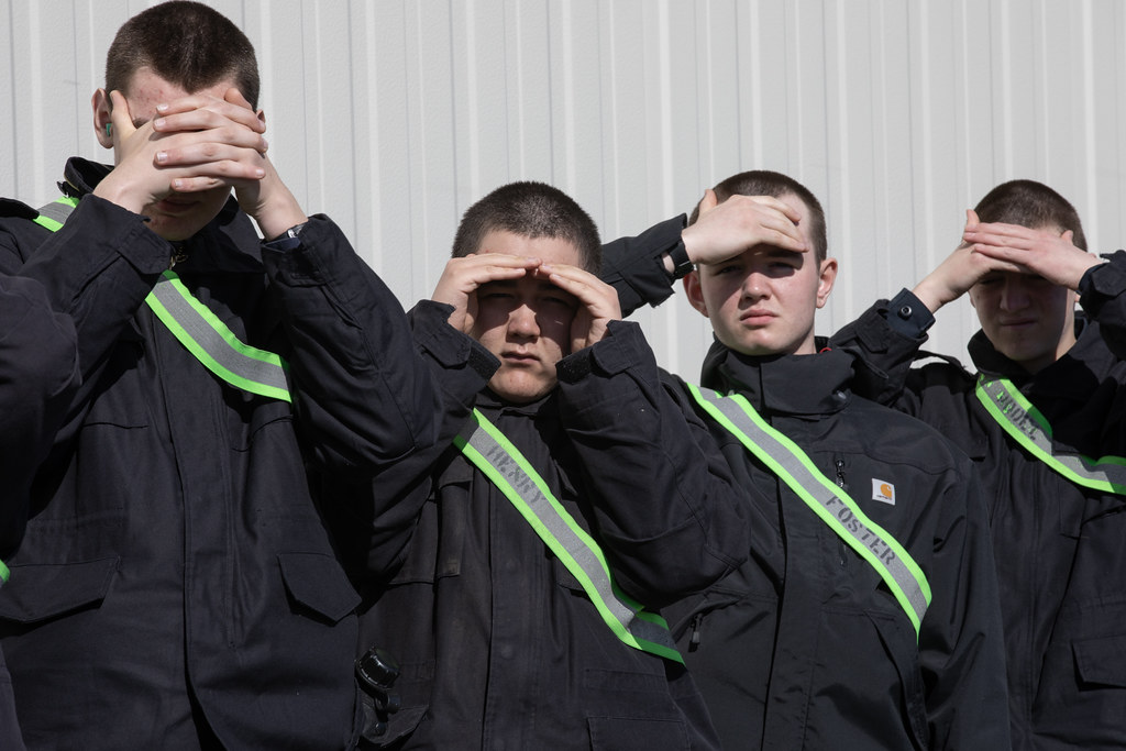 Alaska Military Youth Academy cadets shield their eyes during a sunlit moment at Bryant Army Airfield