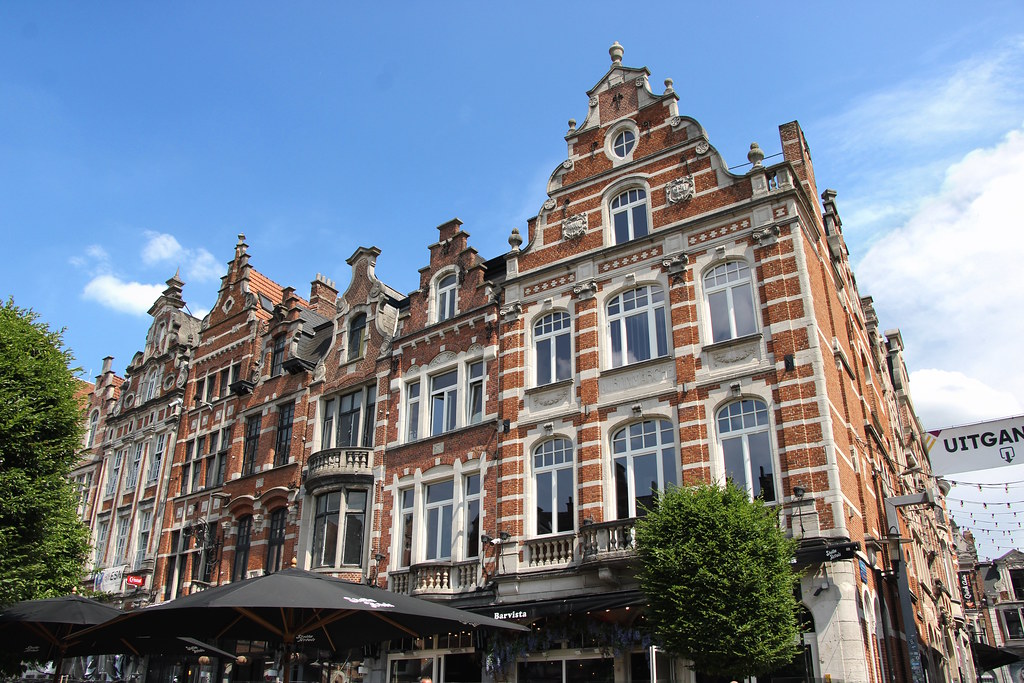 Leuven Old Town: Row of Flemish Stepped-Gable Brick Townhouses with Ground-Floor Shops