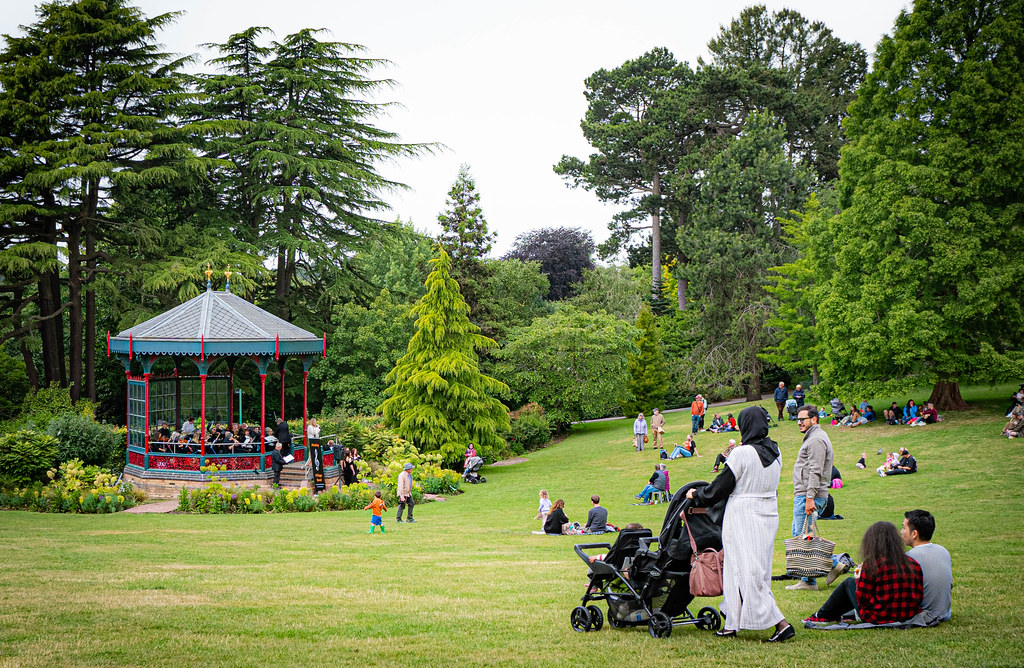 Birmingham Botanic Gardens: Colorful gazebo on the lush lawn with visitors enjoying the grounds