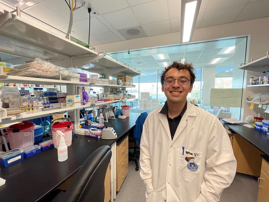 Portrait of a biomedical researcher in a bright, well-equipped laboratory