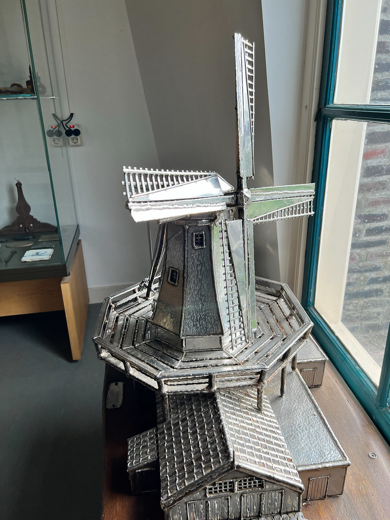 Intricate steel windmill replica inside De Valk Windmill Museum, Leiden