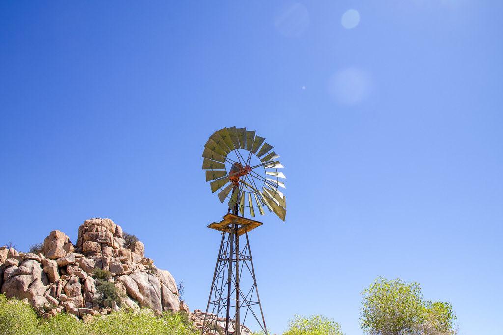 Windmill at Keys Ranch, Joshua Tree National Park—desert windmill tower under a bright blue sky