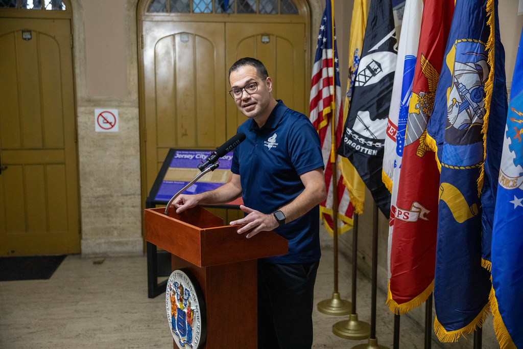 Jersey City Armory ceremony: official delivers remarks during $350,000 veterans housing funding check presentation to SOS Veterans