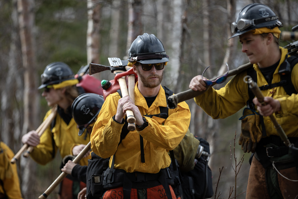 Alaska National Guard, USAF civil engineers, and DFFP firefighters coordinate a forest controlled burn along a constructed fireline at Joint Base Elmendorf-Richardson