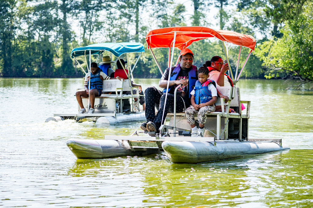 Father's Day Boating: Family Pontoon Ride on a Sunlit River with Colorful Canopies