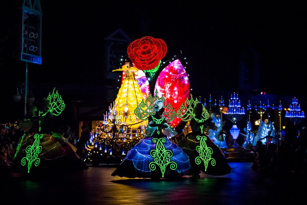 Paint the Night Parade at Disneyland: Neon-lit floats and luminous costumes illuminate a nighttime procession