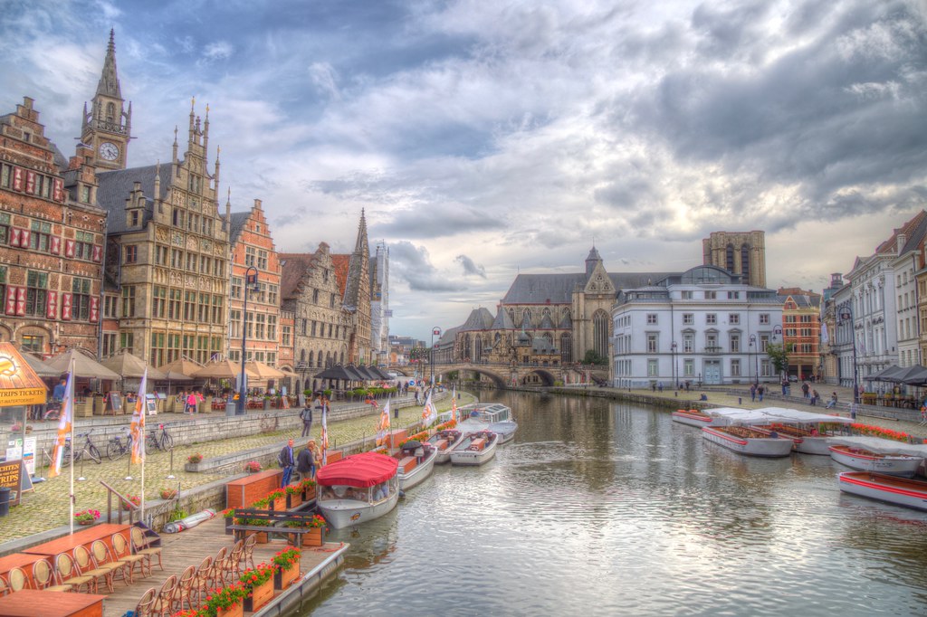 Graslei Canal, Ghent: Historic guild houses along the riverfront under a dramatic sky