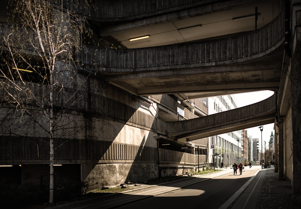 Norrköping, April 19, 2014 — Sunlit curves of concrete ramps weave above a pedestrian street