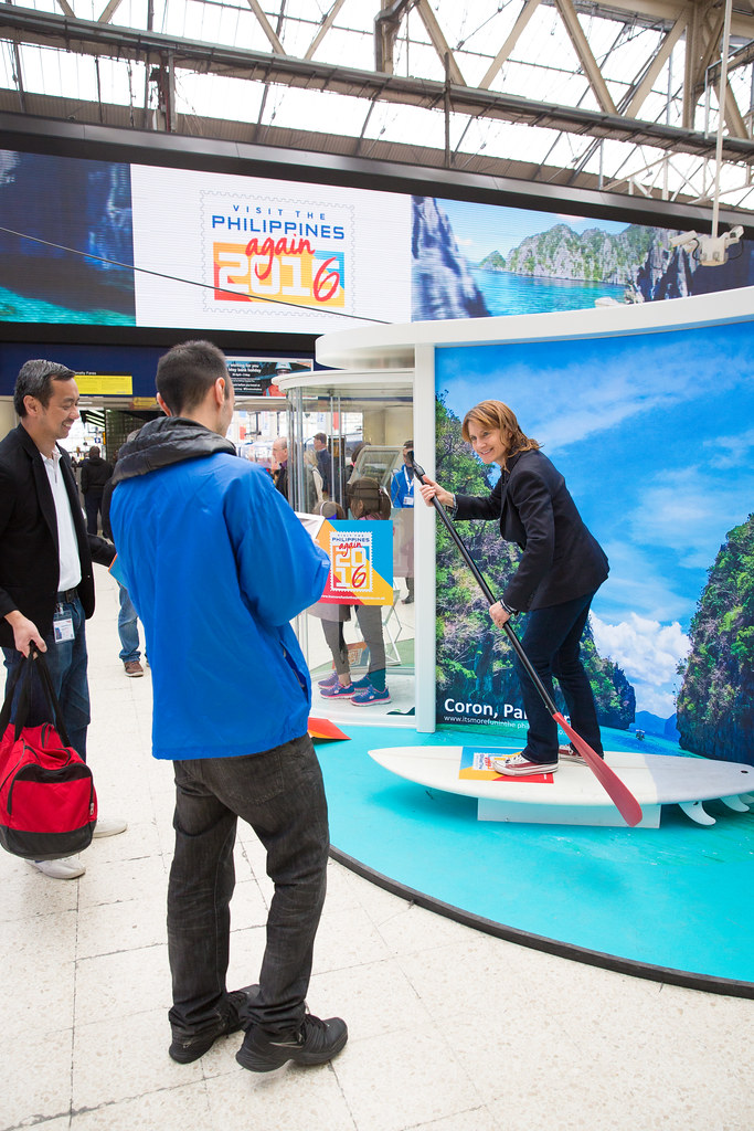 Visit the Philippines Expo 2016 booth: stand-up paddleboard display against a tropical backdrop