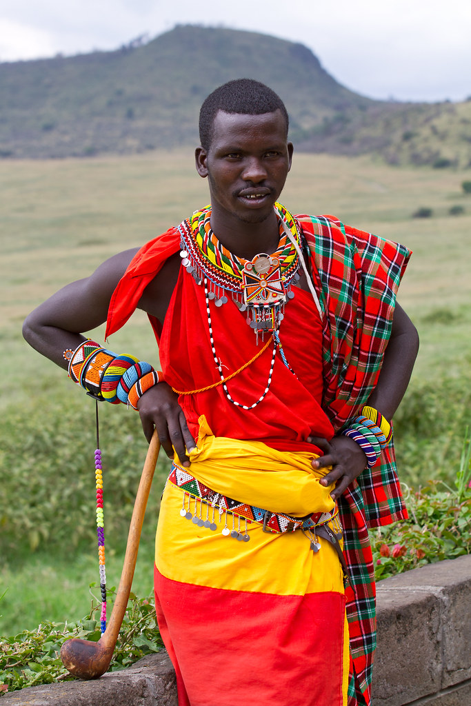 Maasai man in red shuka and colorful beadwork, Rift Valley savanna, Kenya