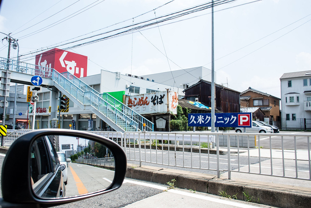 From the Car Window: Wide-Angle Street Scene in Japan with Overpass, Signage, and Suburban Commerce