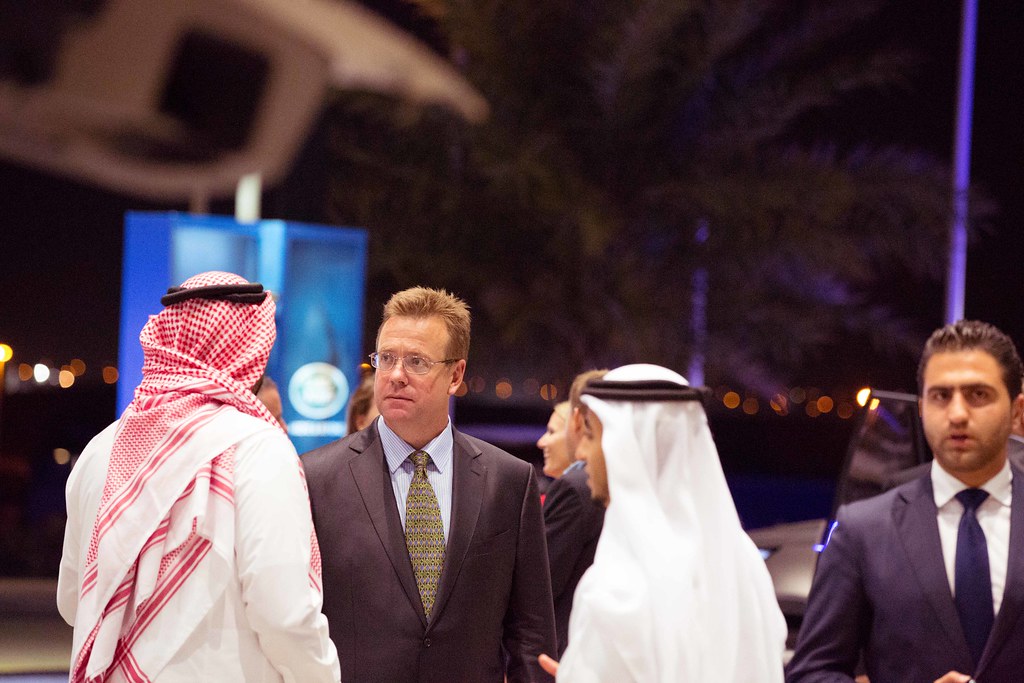 Land Rover Discovery Sport launch event in Dubai, UAE: executives mingle with guests in business and traditional Emirati attire at night