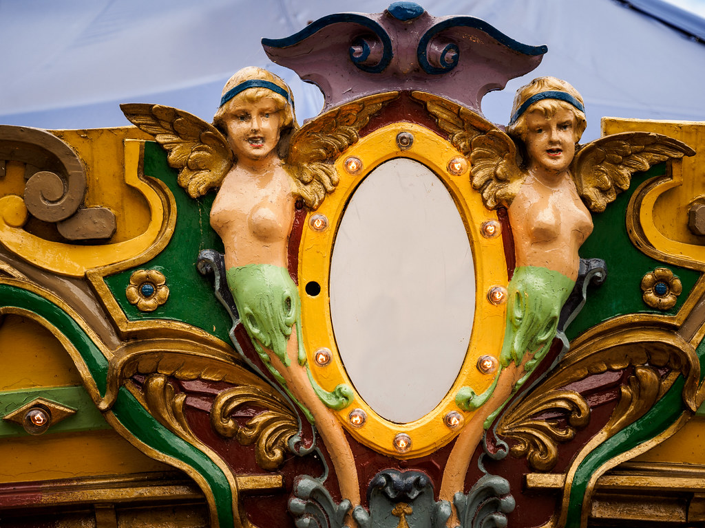 Ornate Carousel Crest with Winged Cherubs and Central Oval Mirror