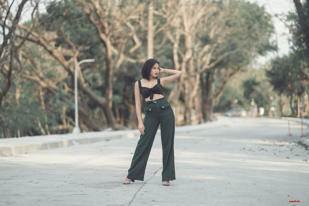 Urban Portrait on a Tree-Lined Avenue: Knotted Black Crop Top and Dark Green Wide-Leg Trousers