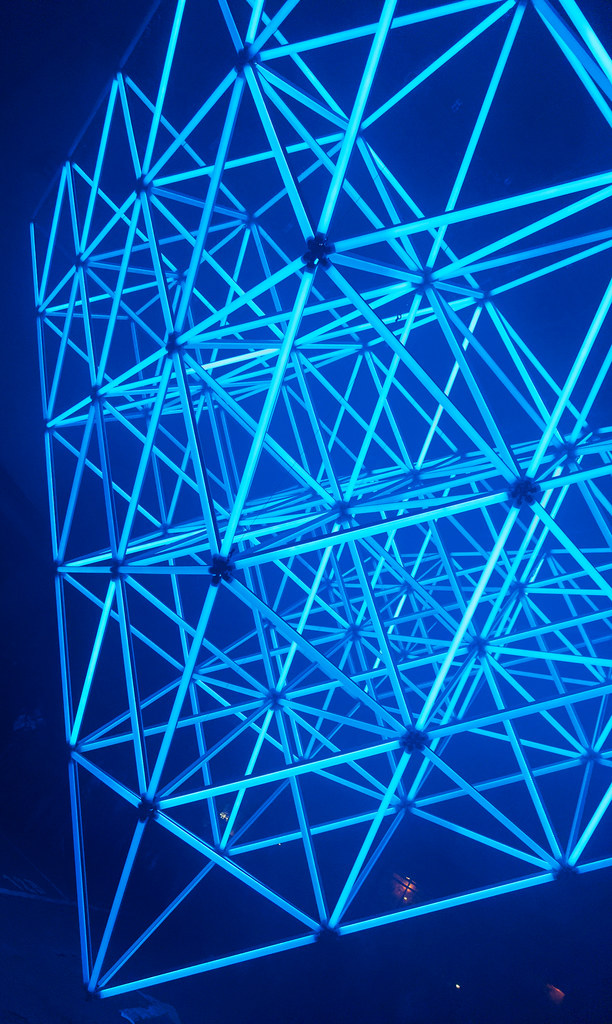 Stalactite: blue-lit suspended lattice inside the Former Citroën garage at Bright Brussels